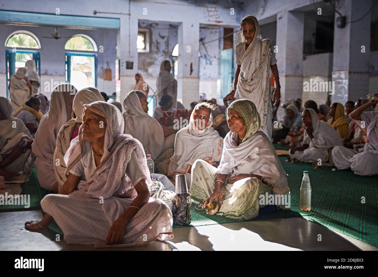 Vrindavan, India, August 2009. Widows gathered to pray inside an ashram ...