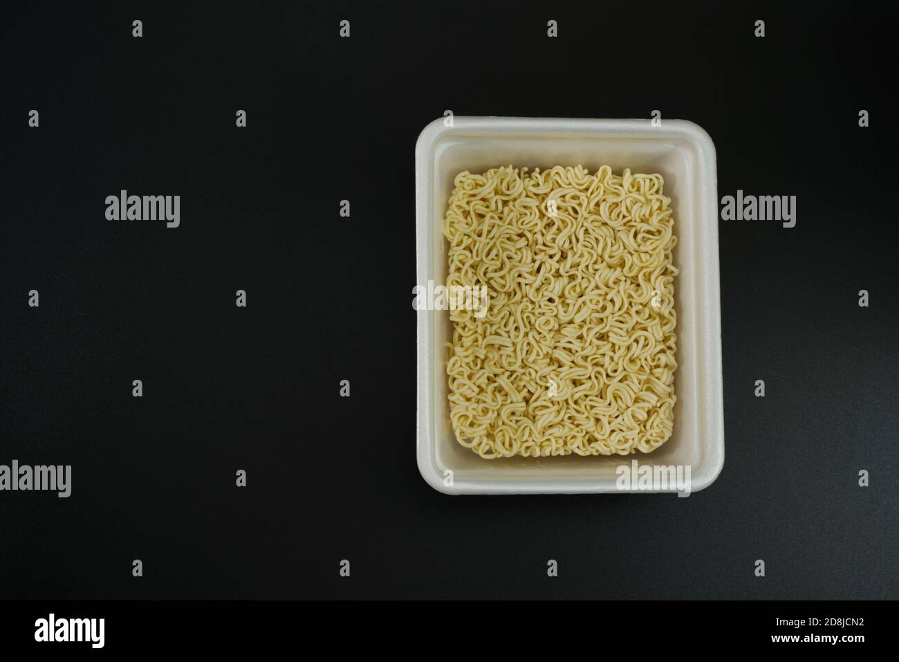 Dry instant noodles in rectangle plastic plate, top view Stock Photo ...