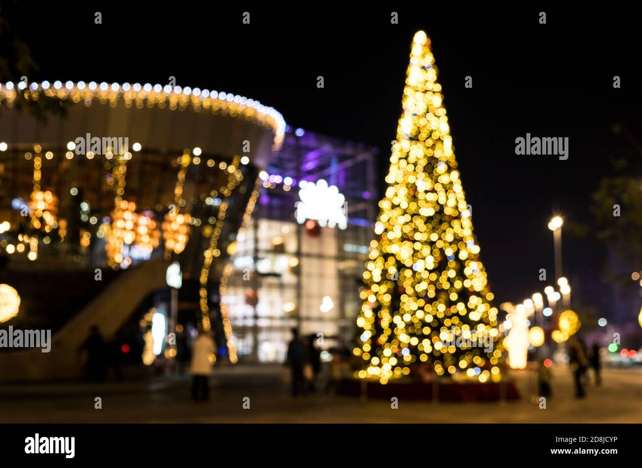 Christmas tree with lights glowing in a city Stock Photo - Alamy