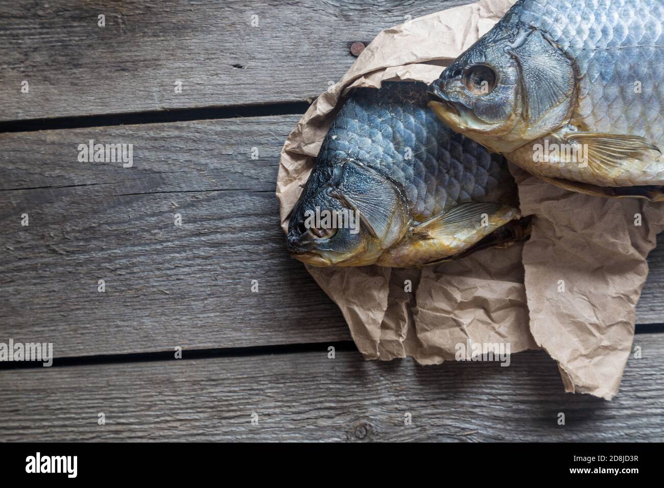 Dried Volga bream vobla in a crumpled kraft paper roll, delicious beer ...