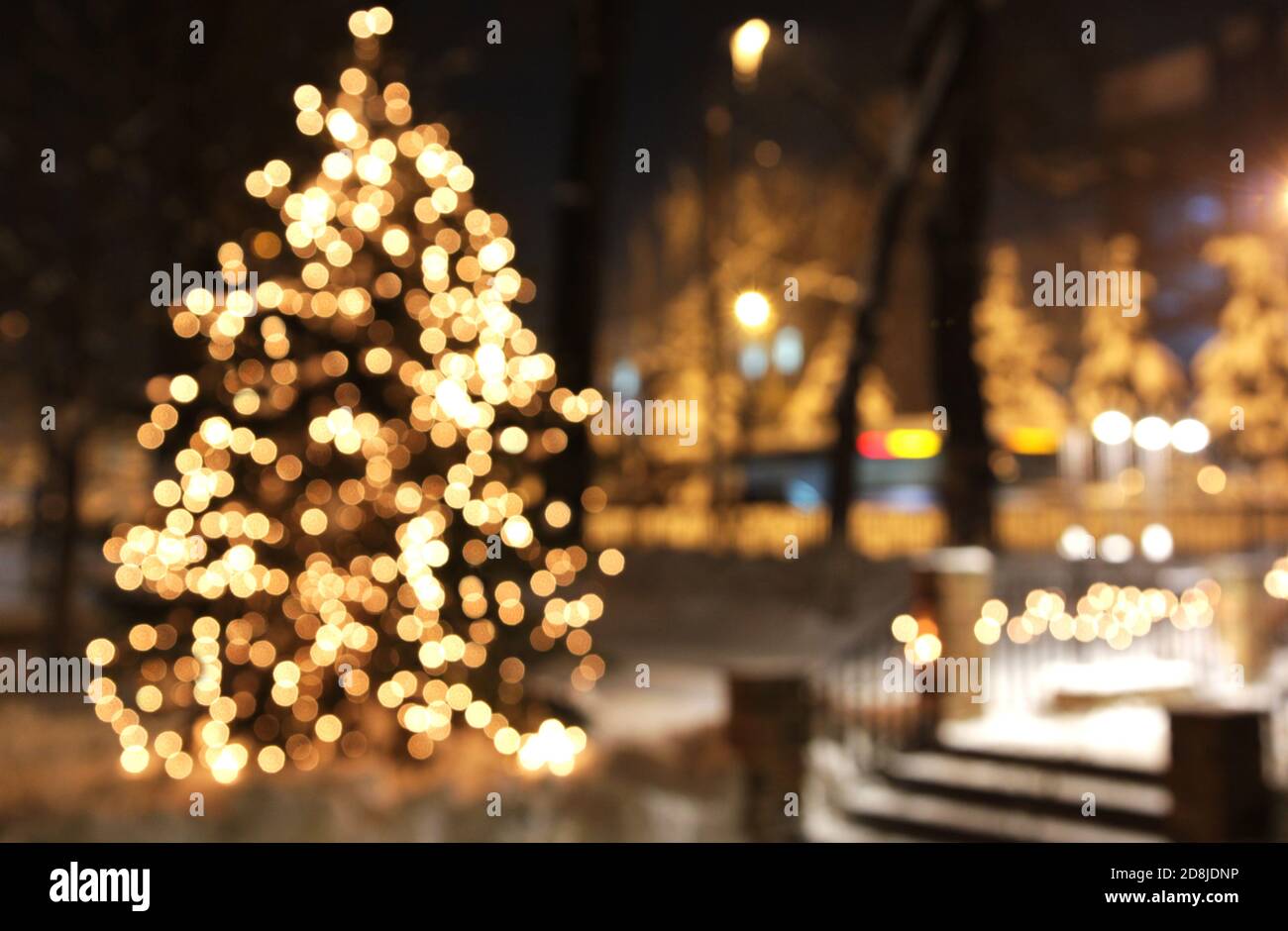 Christmas tree with lights glowing and snow Stock Photo - Alamy