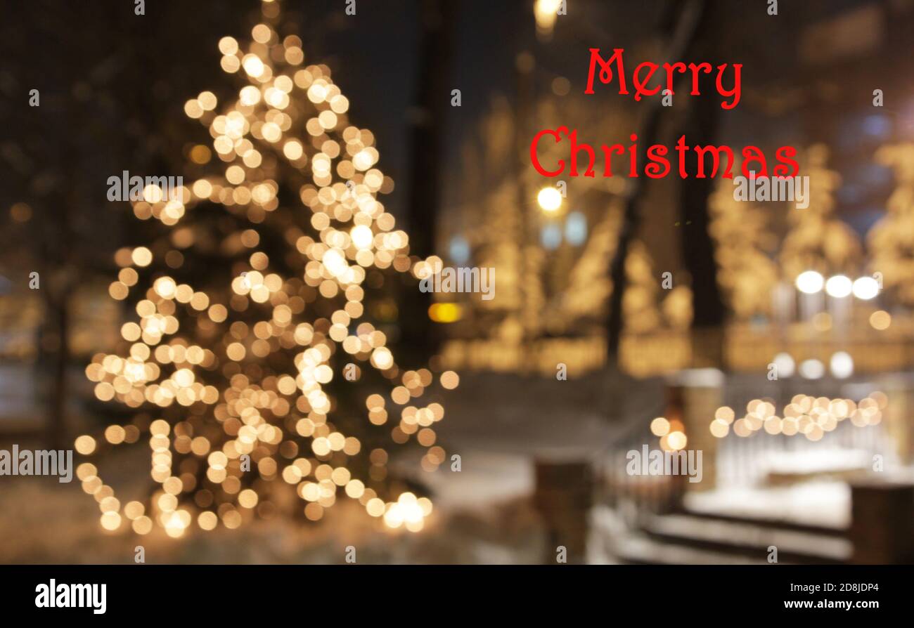 Christmas tree with lights glowing and snow Stock Photo - Alamy