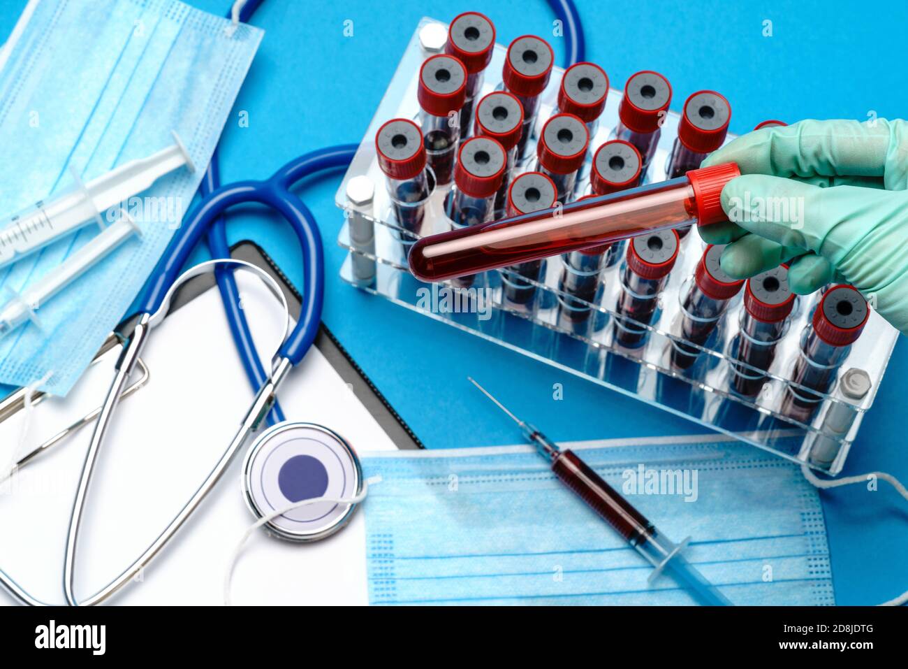 lab technician assistant or doctor holding a blood sample in test tube ...