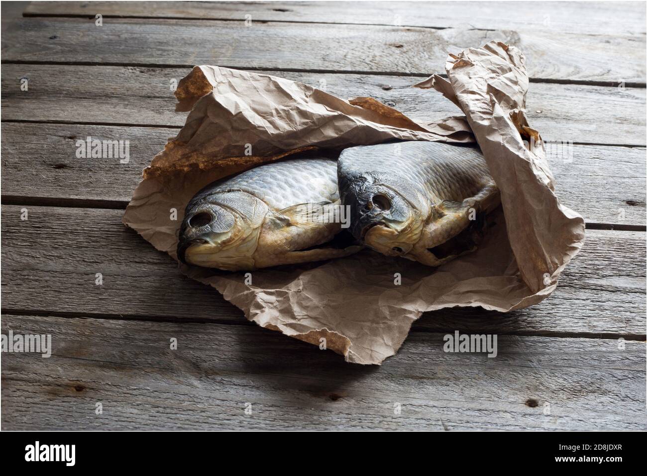 Dried Volga bream vobla in a crumpled kraft paper roll Stock Photo - Alamy