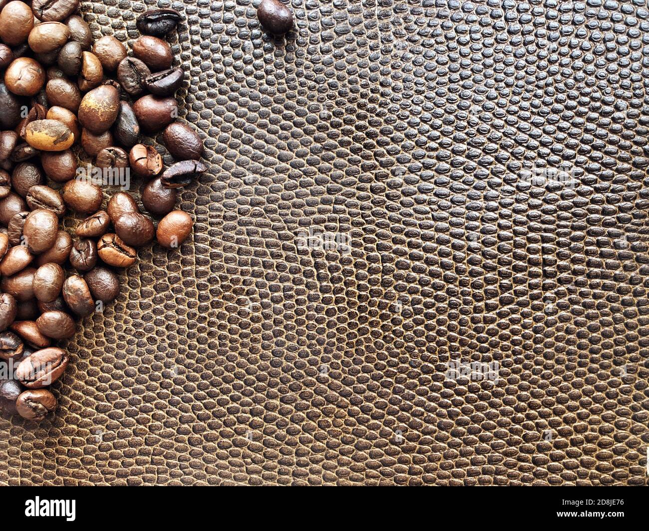 Coffee beans close-up on a leather surface. Top view roasted coffee ...