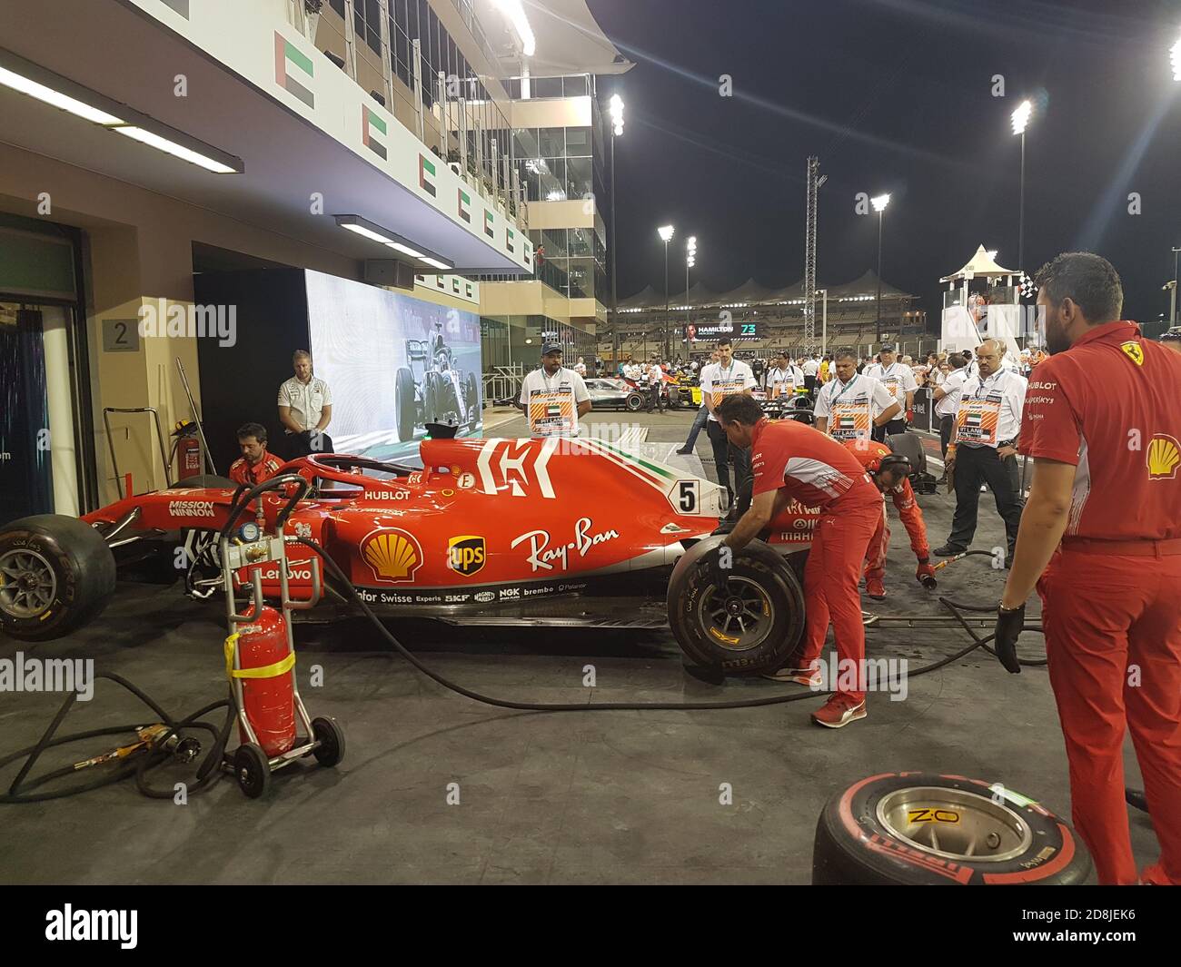 Ferrari Mechanical team members take care of car wheels after the races ...