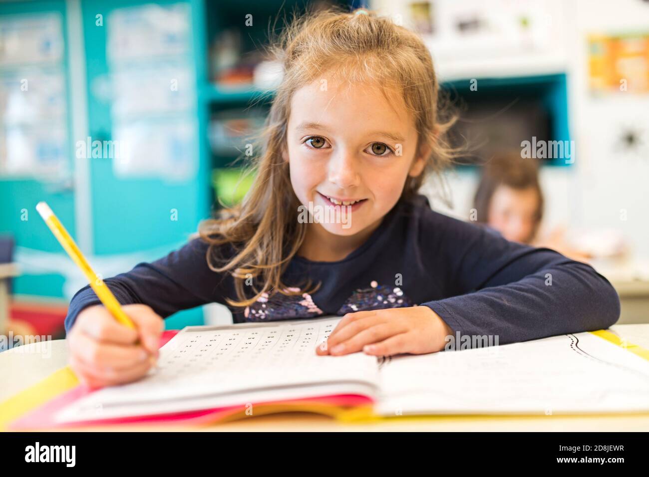 education and school concept little student girl studying at school ...