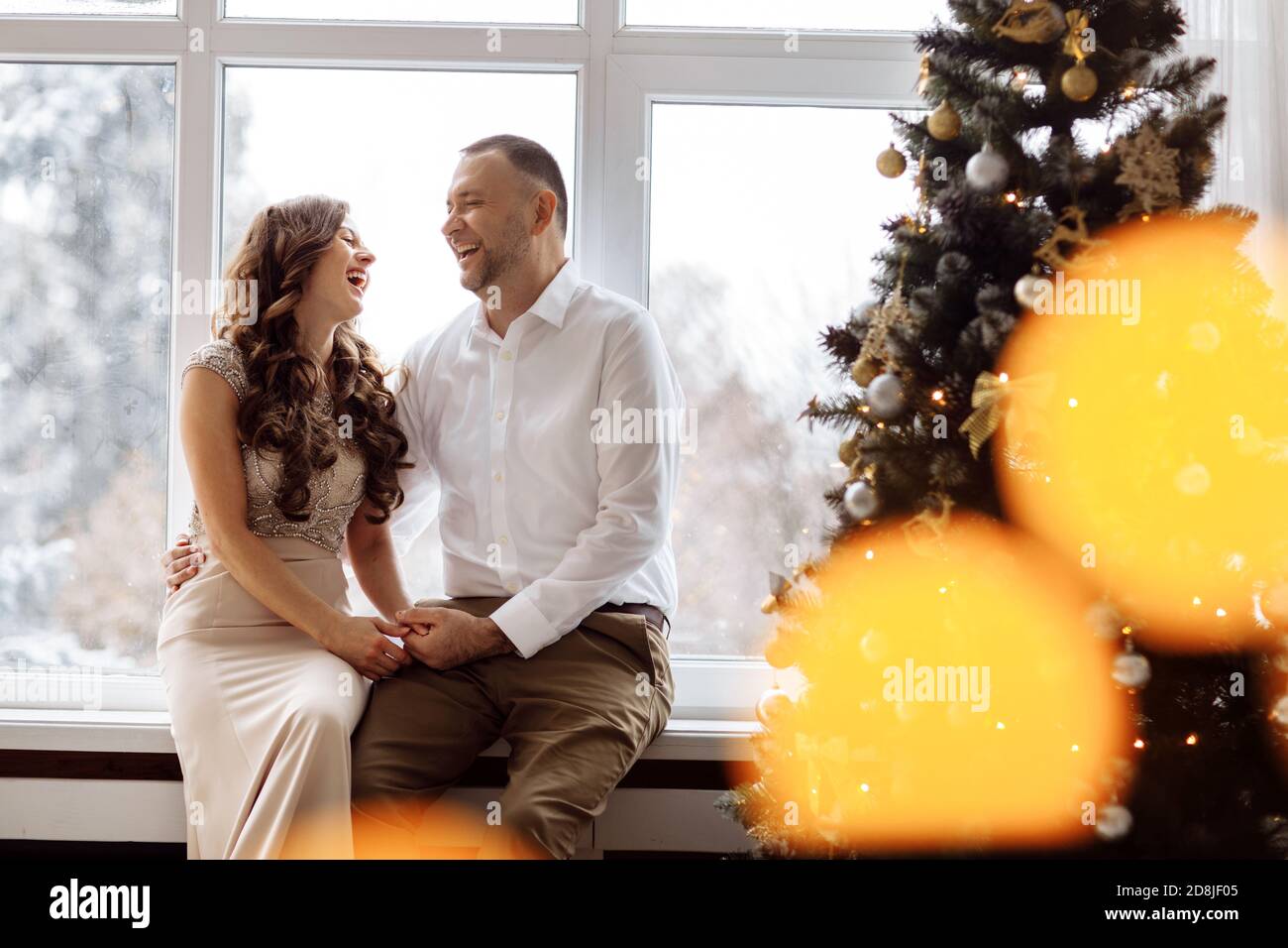 couple in love in festive clothes sitting and hugging near the large ...