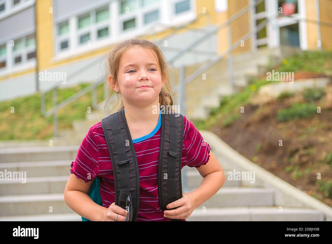 A nice Portrait of cute girl with backpack at school Stock Photo - Alamy