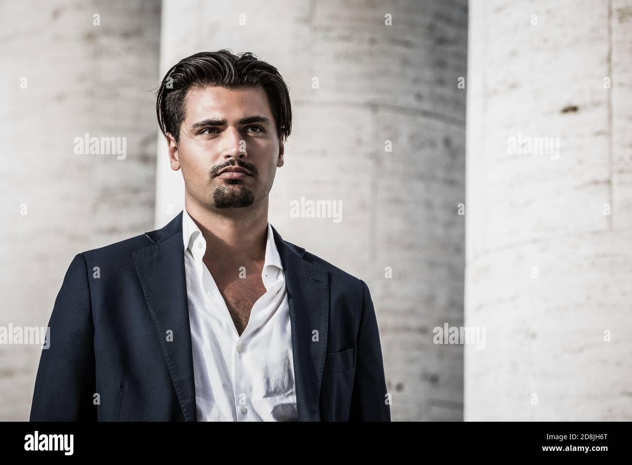 Portrait of young man with trendy style. Trendy hair and goatee. He ...