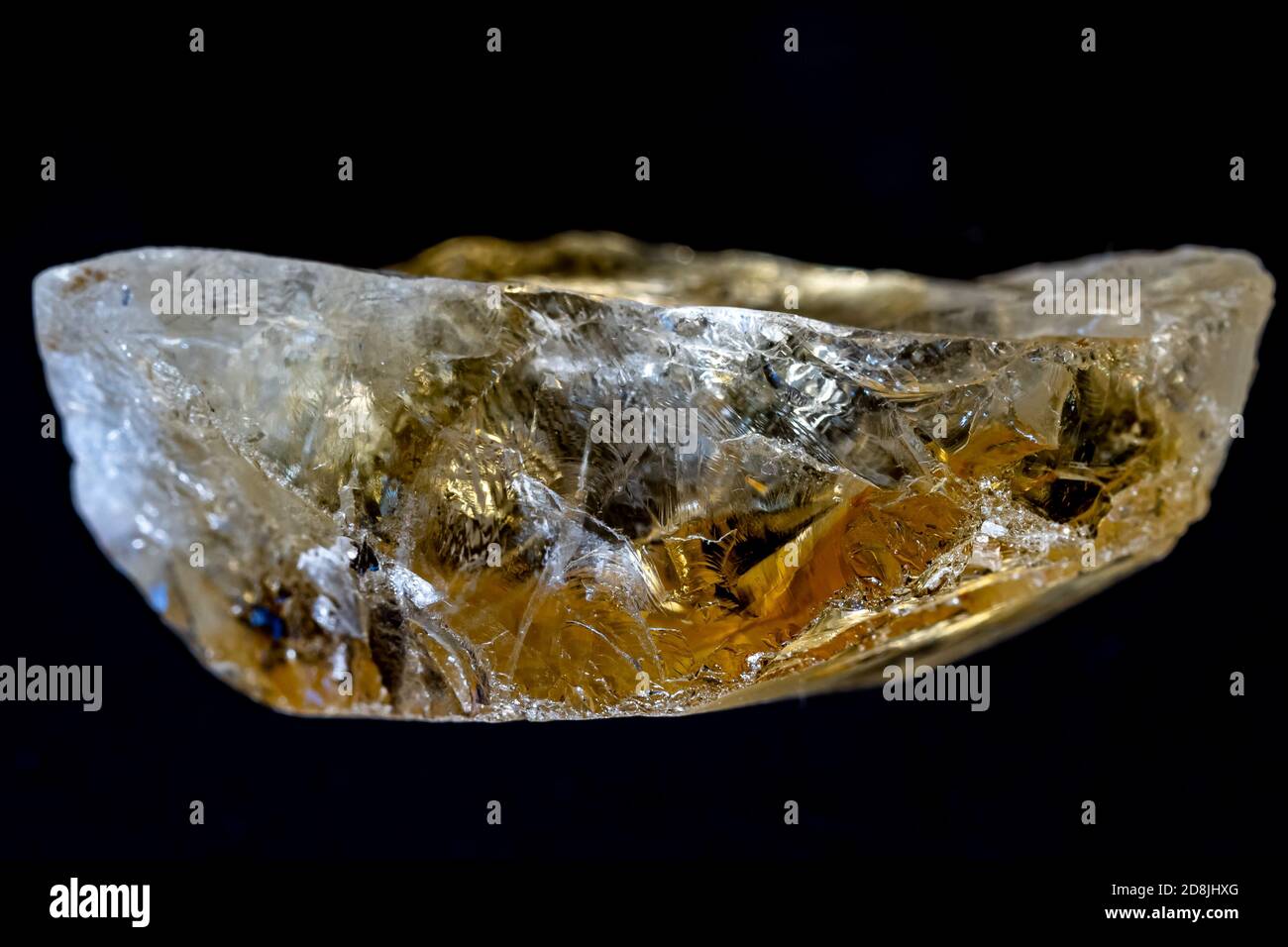 Natural citrine quartz , yellow raw stone on a black background. The ...