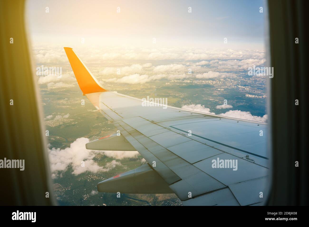 View of an airplane wing from the window on the city. Flight on a ...