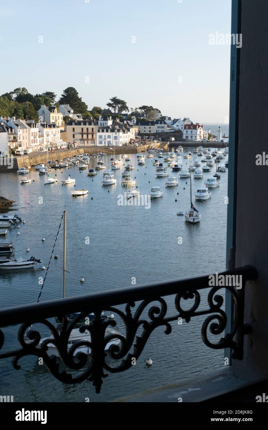 Balcony view out of a window of the harbour at Sauzon on the island of ...