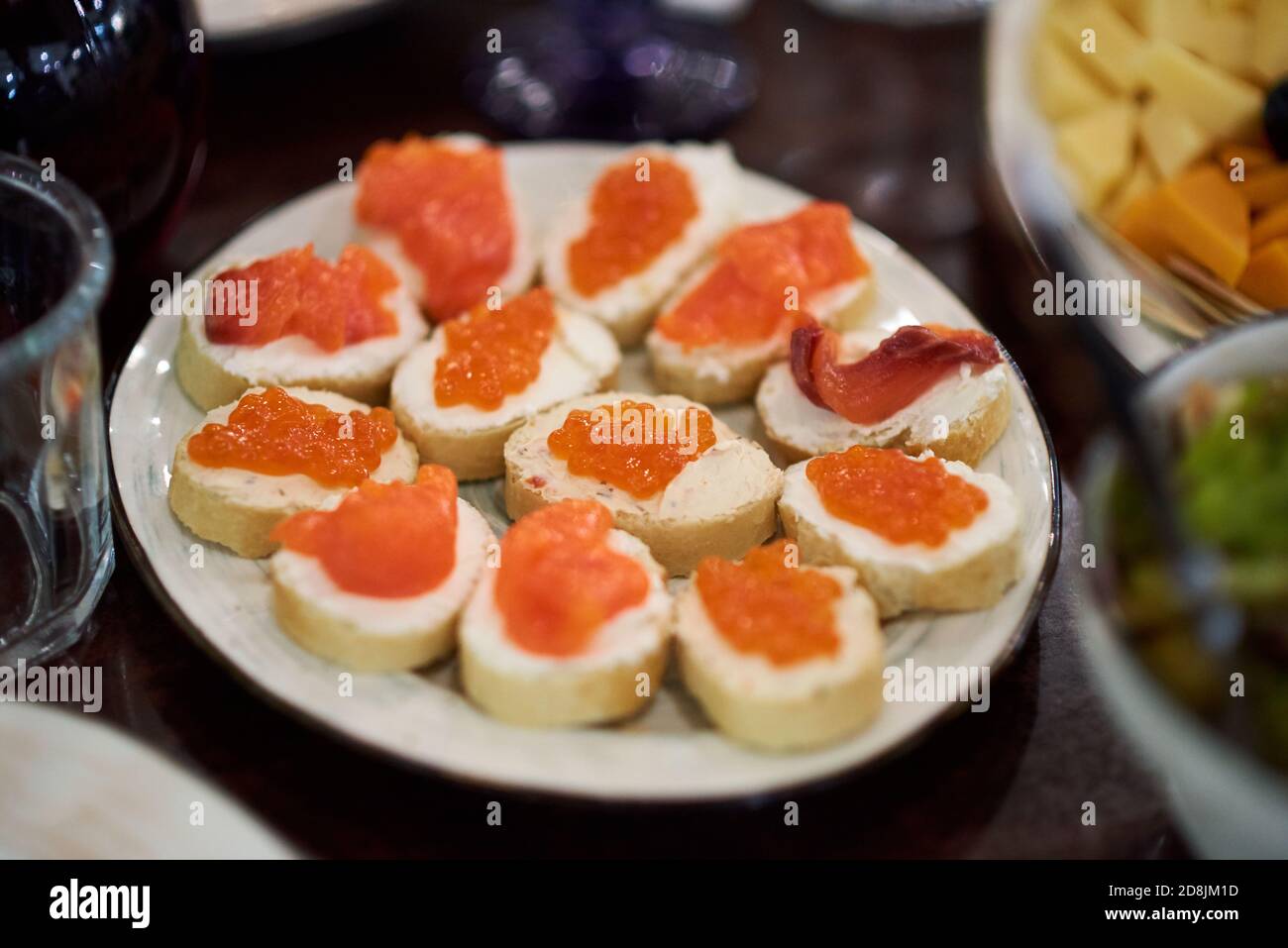 Small appetizers with red caviar and fish Stock Photo - Alamy