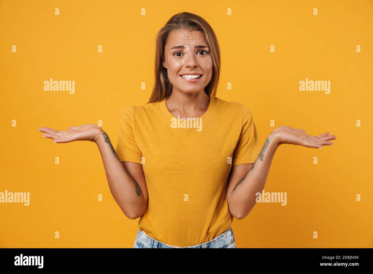 Image of nice confused woman holding and showing copyspace isolated ...