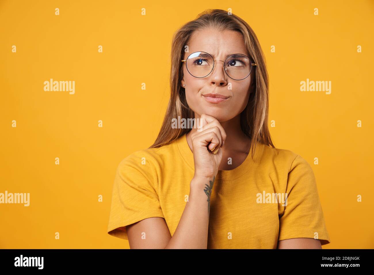 Image of brooding nice woman in eyeglasses thinking and looking aside ...
