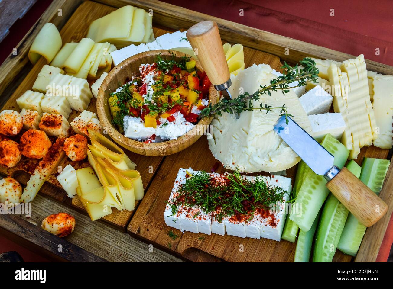 Closeup shot of an assortment of different cheese types on a wooden ...