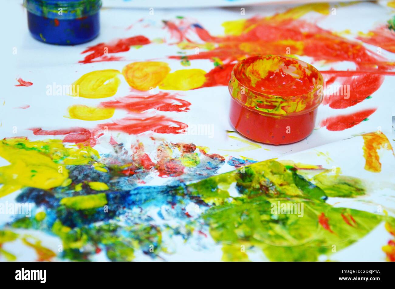 can with paint on a canvas background with an abstract pattern. child's ...
