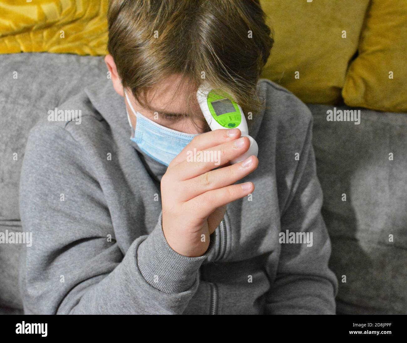 Teenage boy checking his body temperature Stock Photo - Alamy