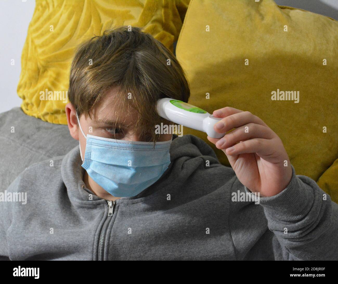 Teenage boy checking his body temperature Stock Photo - Alamy