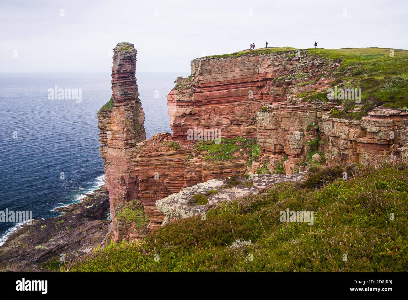 Famous Orkney sea stack in summer with people on the cliff Stock Photo ...