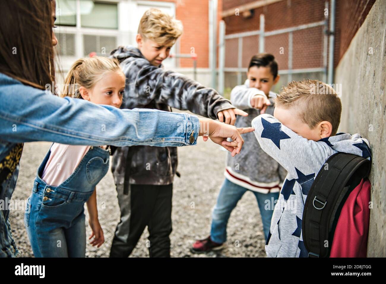 sad intimidation moment Elementary Age Bullying in Schoolyard Stock ...