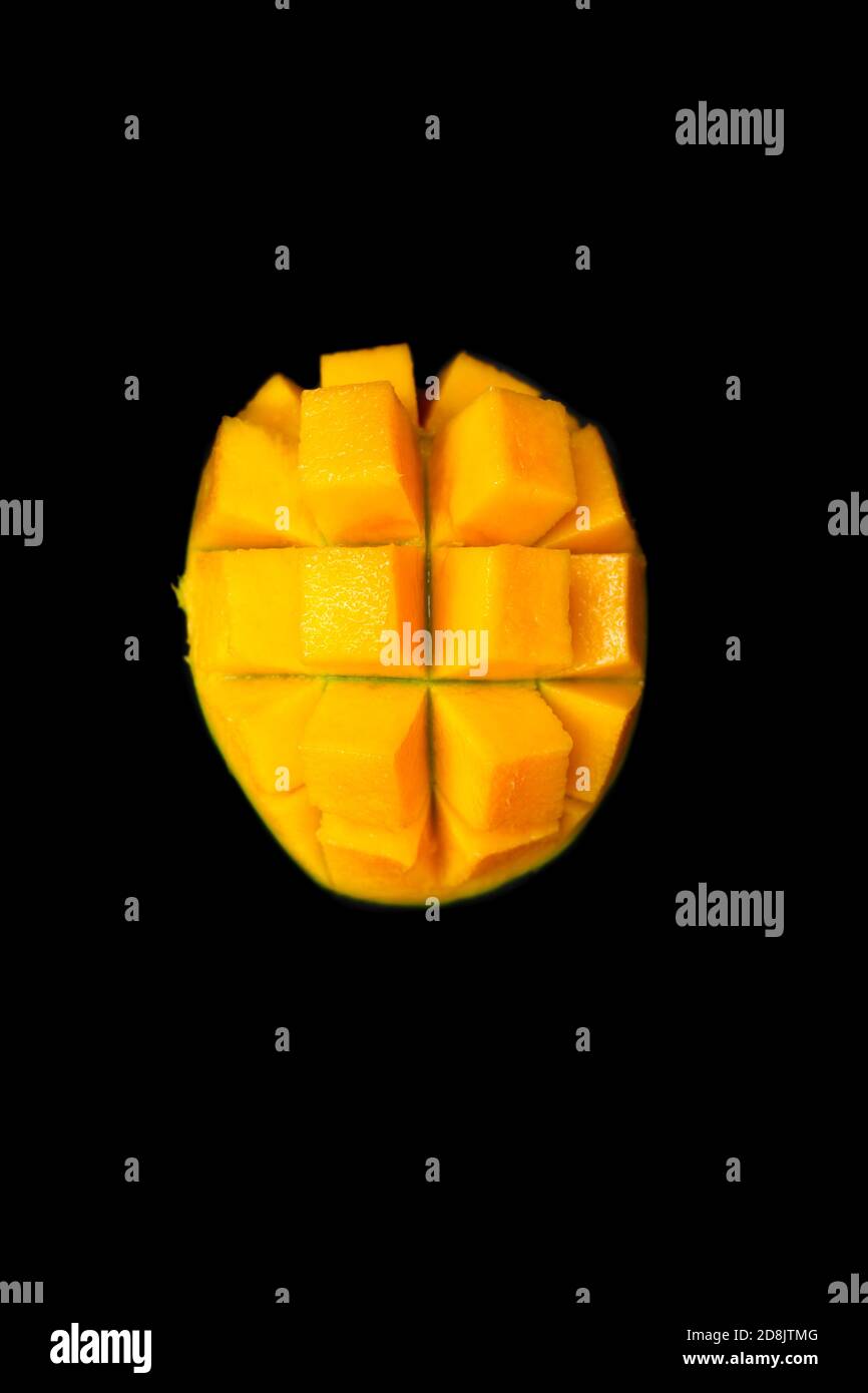 A square mango slice isolated from a black background, perfect for ...