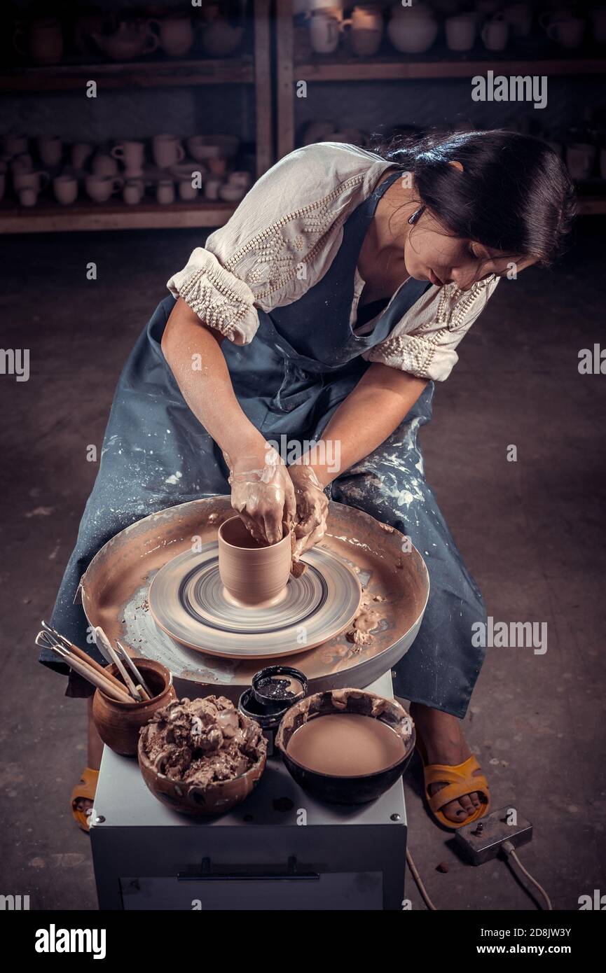 Stylish craftsmen at his wheel creating a new masterpiece. Making ...