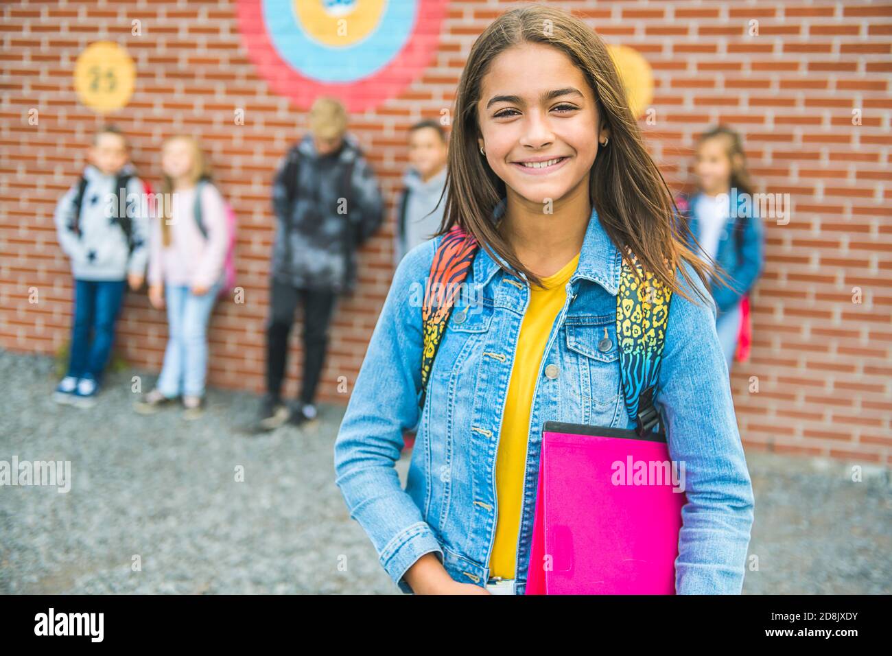 kid on the school brick background having fun Stock Photo - Alamy