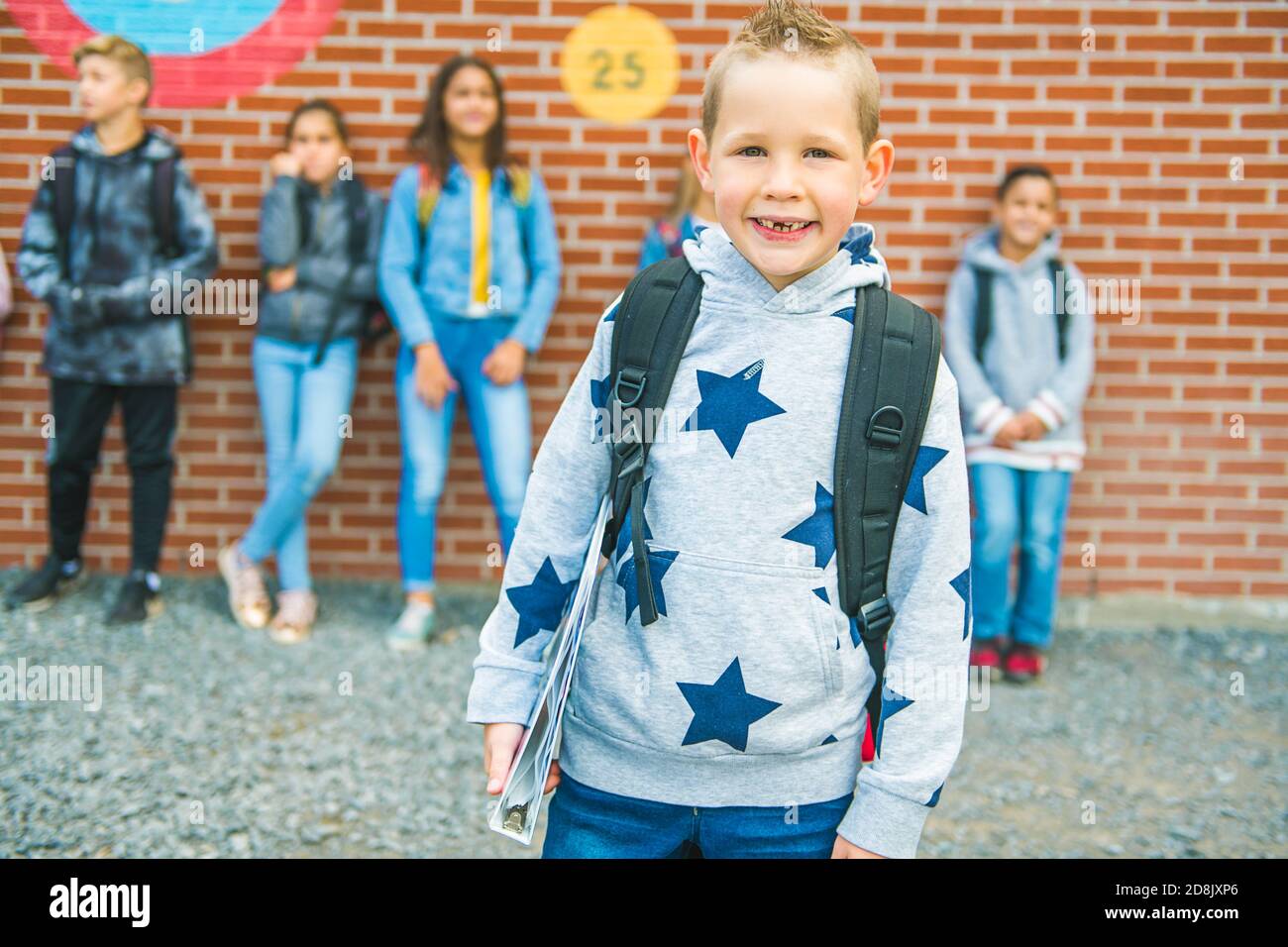 kid on the school brick background having fun Stock Photo - Alamy