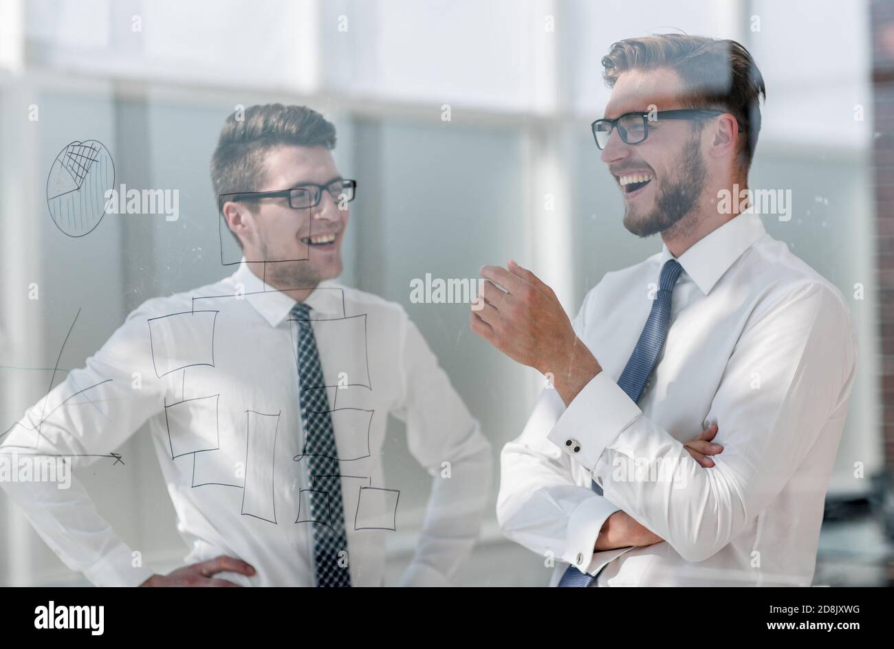 close up.two employees talking standing in the office Stock Photo - Alamy
