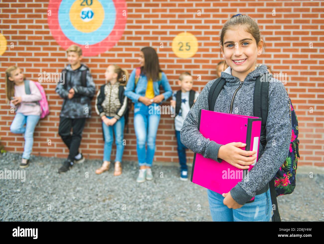 kid on the school brick background having fun Stock Photo - Alamy