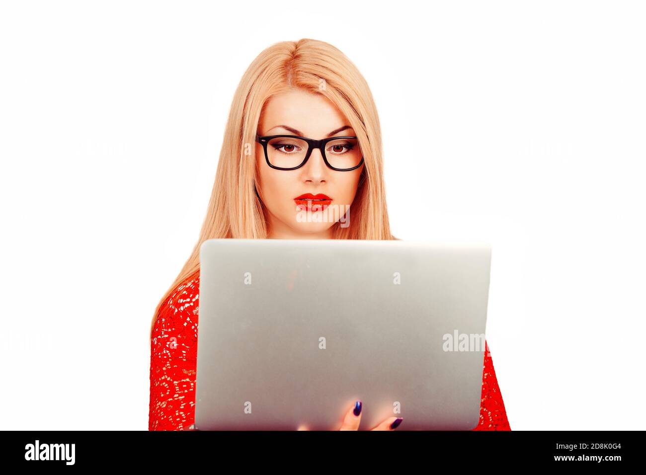 Charming lady standing on the grey background with laptop in her hands ...