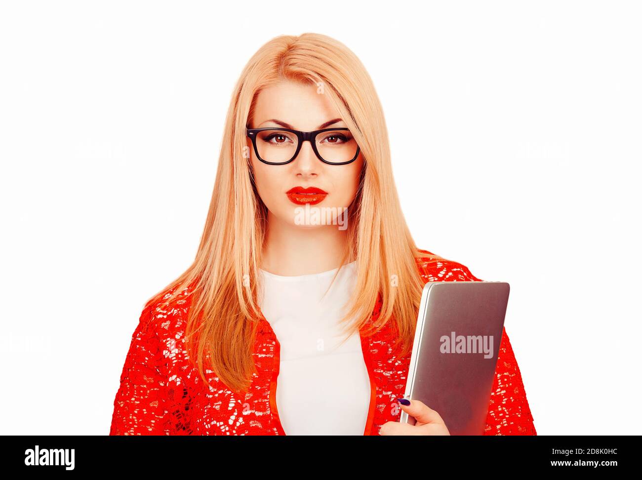 A beautiful young woman in eyeglasses standing with a laptop in her ...