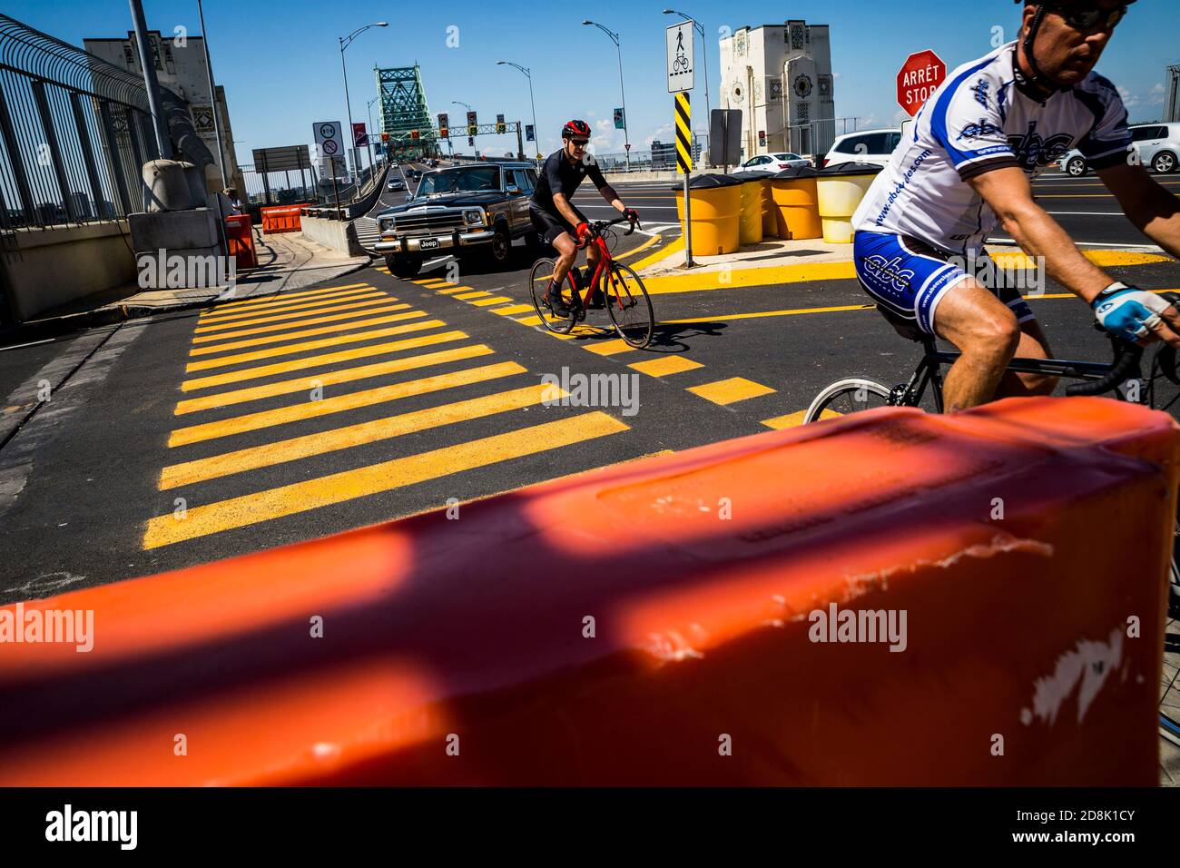 Cyclists at a zebra crossing (crosswalk) on the Jacques Cartier Bridge ...