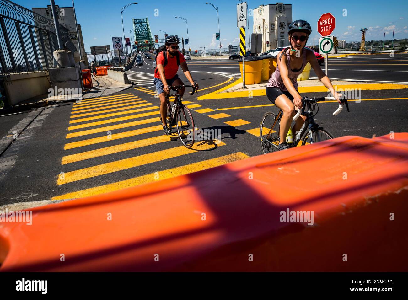 Cyclists on a zebra crossing (crosswalk) on the Jacques Cartier Bridge ...