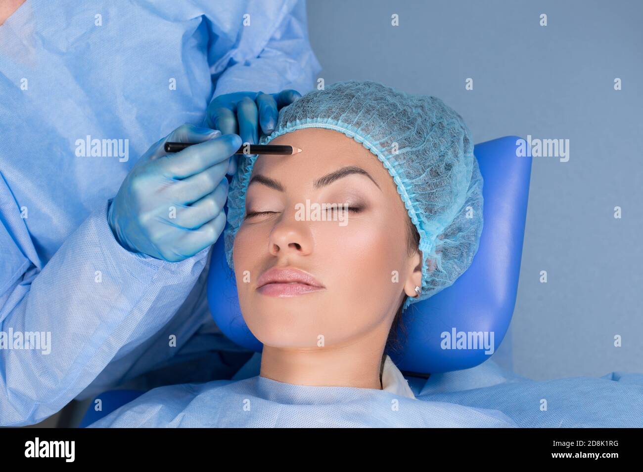 Doctor preparing for forehead lift surgery procedure about to draw lift ...