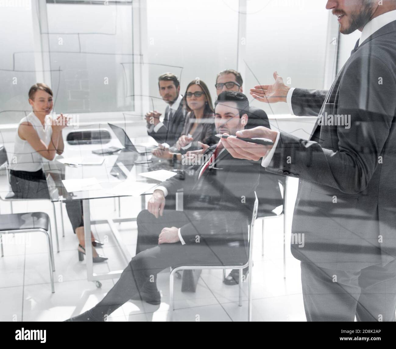 Working business people behind glass walls Stock Photo - Alamy