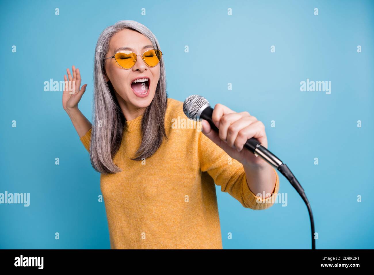 Close-up headshot photo of charming lovely singer old lady holding ...