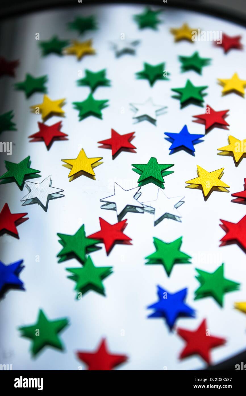 Colorful confetti in the form of small stars on the surface of the ...