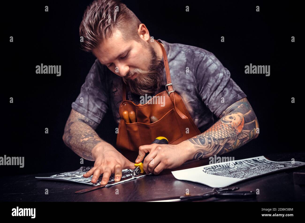 Leather master focused on his work at his shop Stock Photo - Alamy
