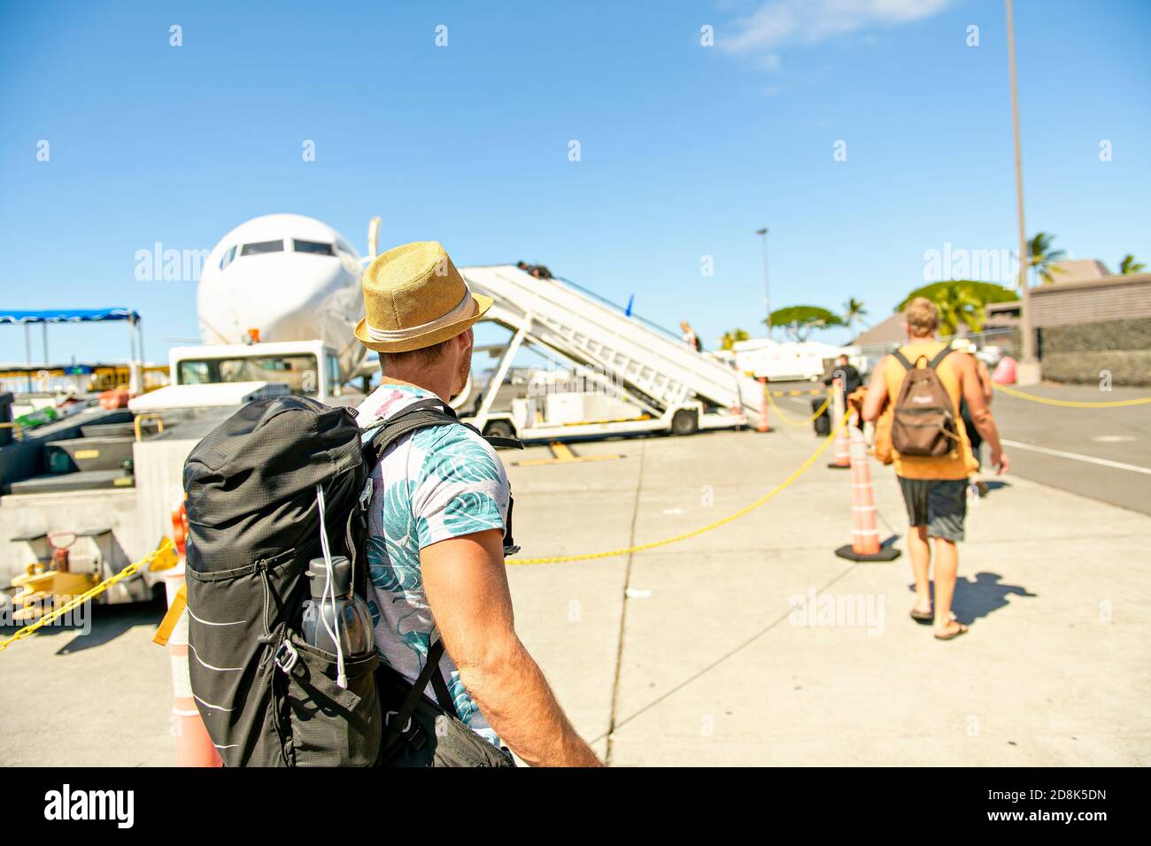 A Young traveling man get in the plane with passport on the landing ...