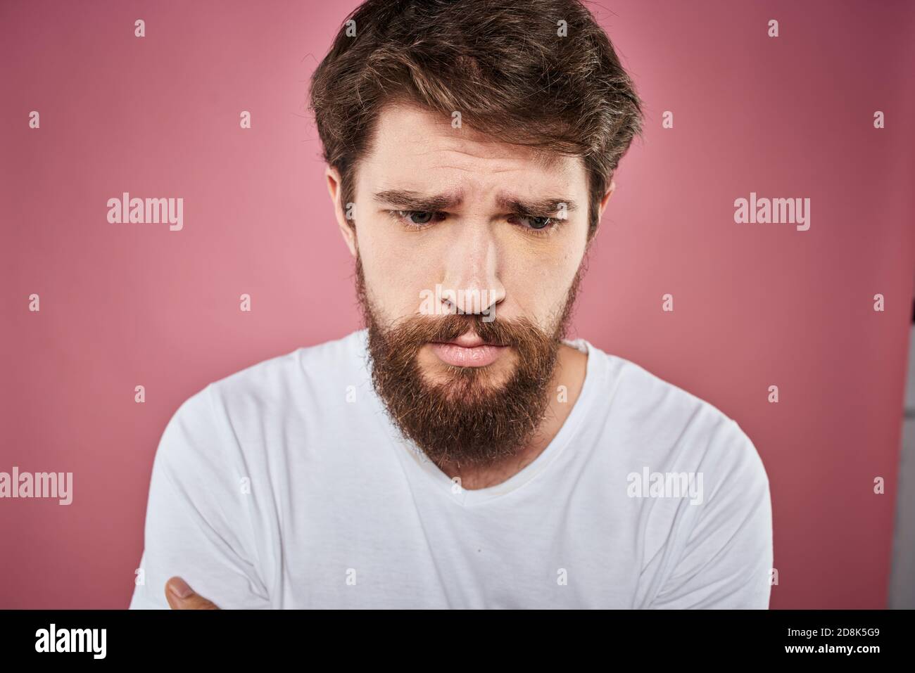 bearded man in white t-shirt emotions displeased facial expression ...