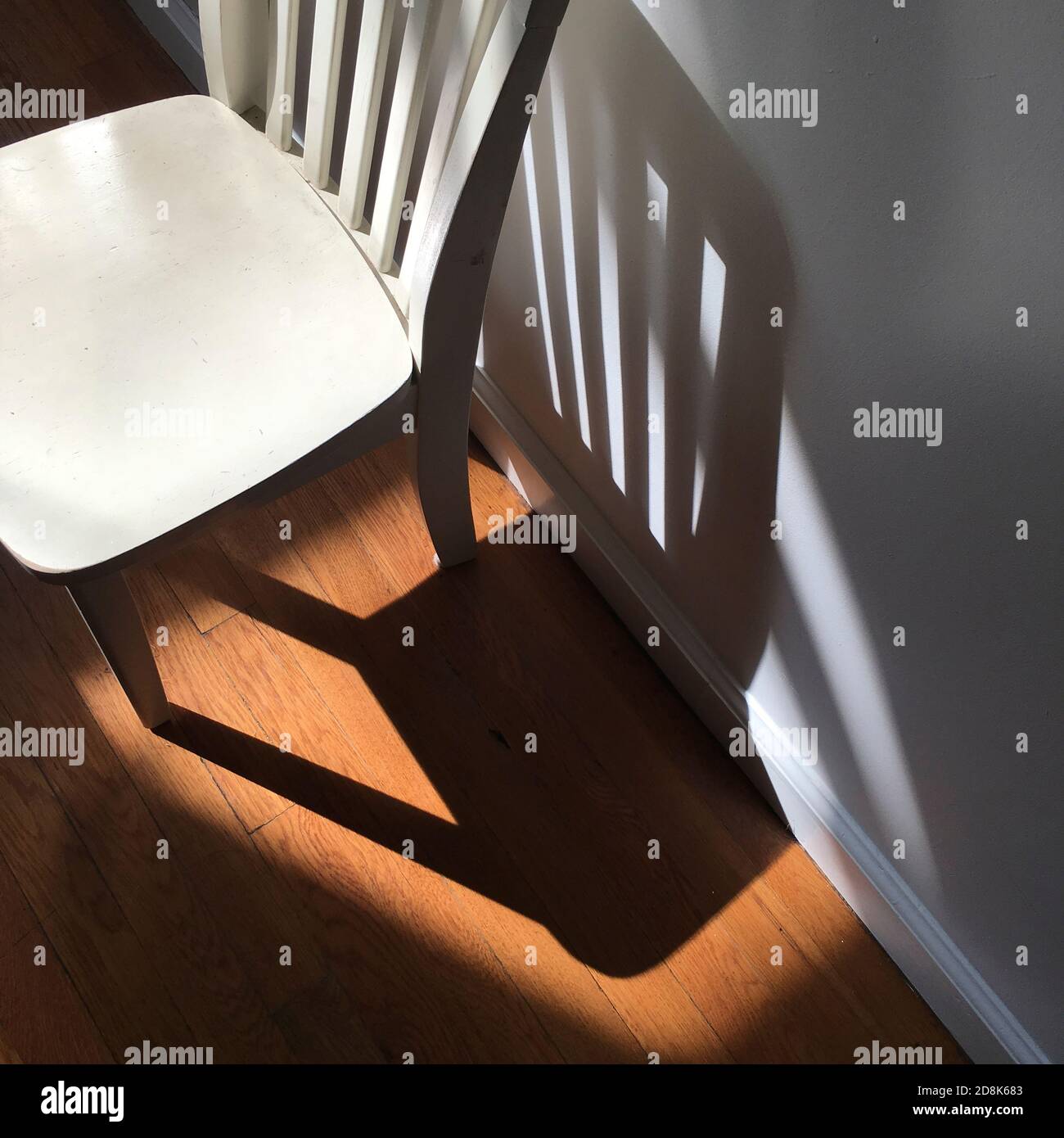 High Angle View of Child's Chair against Wall with Shadows Stock Photo ...