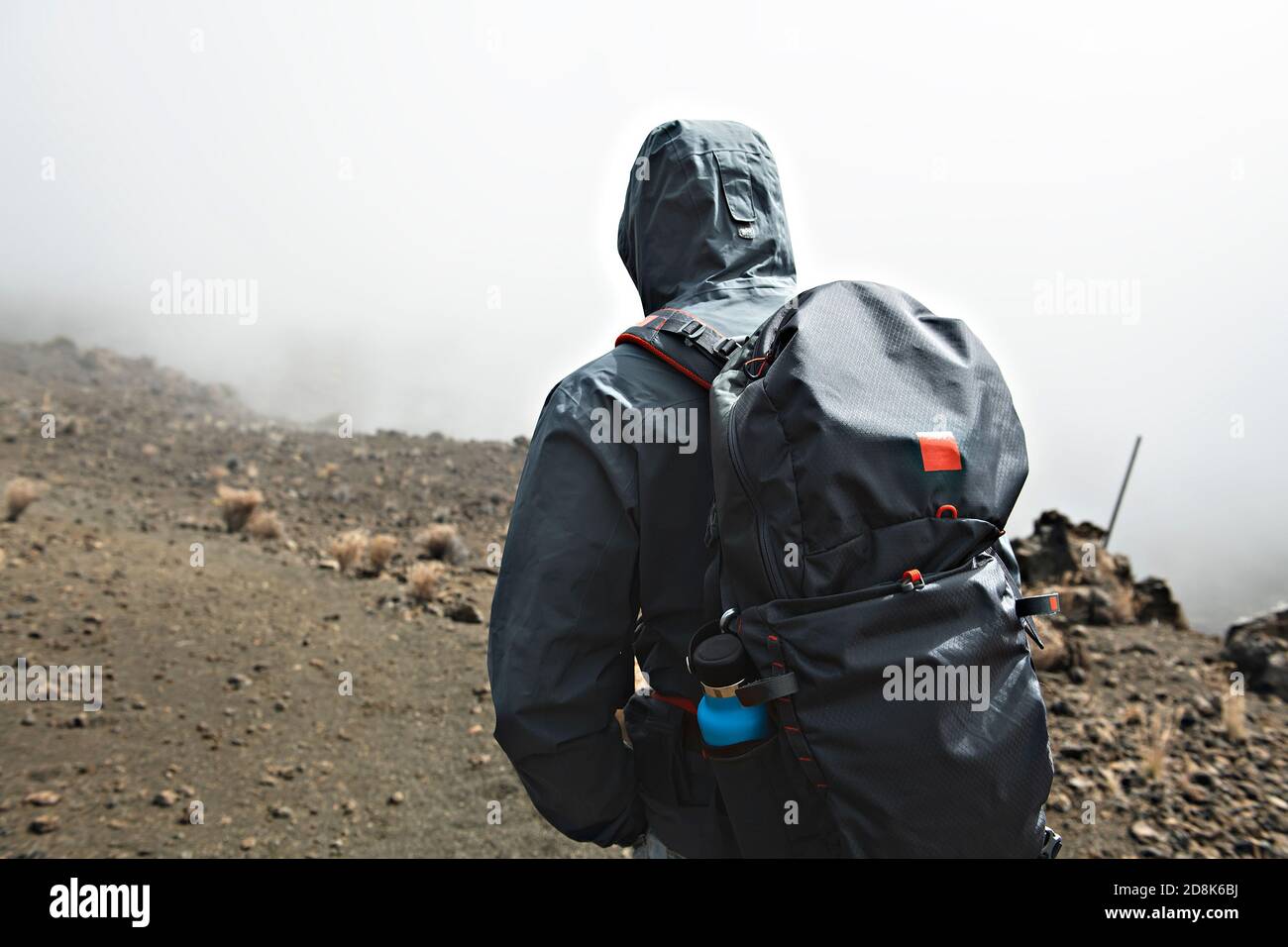A hiking Tourist admiring climb Mauna kea volcano on the Big Island of ...