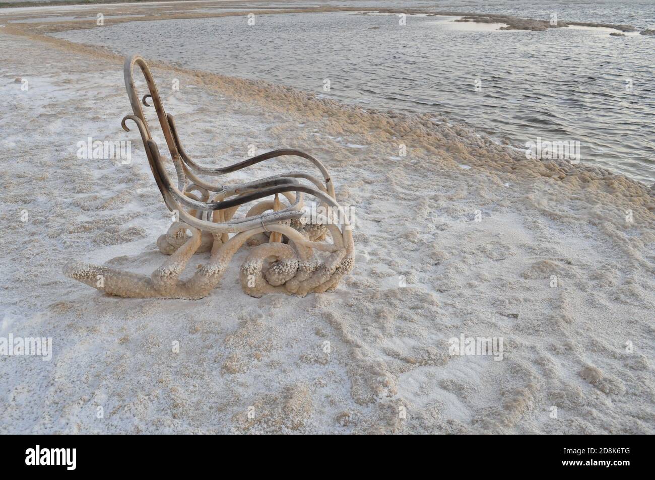 rocking chair covered in salt at the shore of dead sea israel/palestine ...