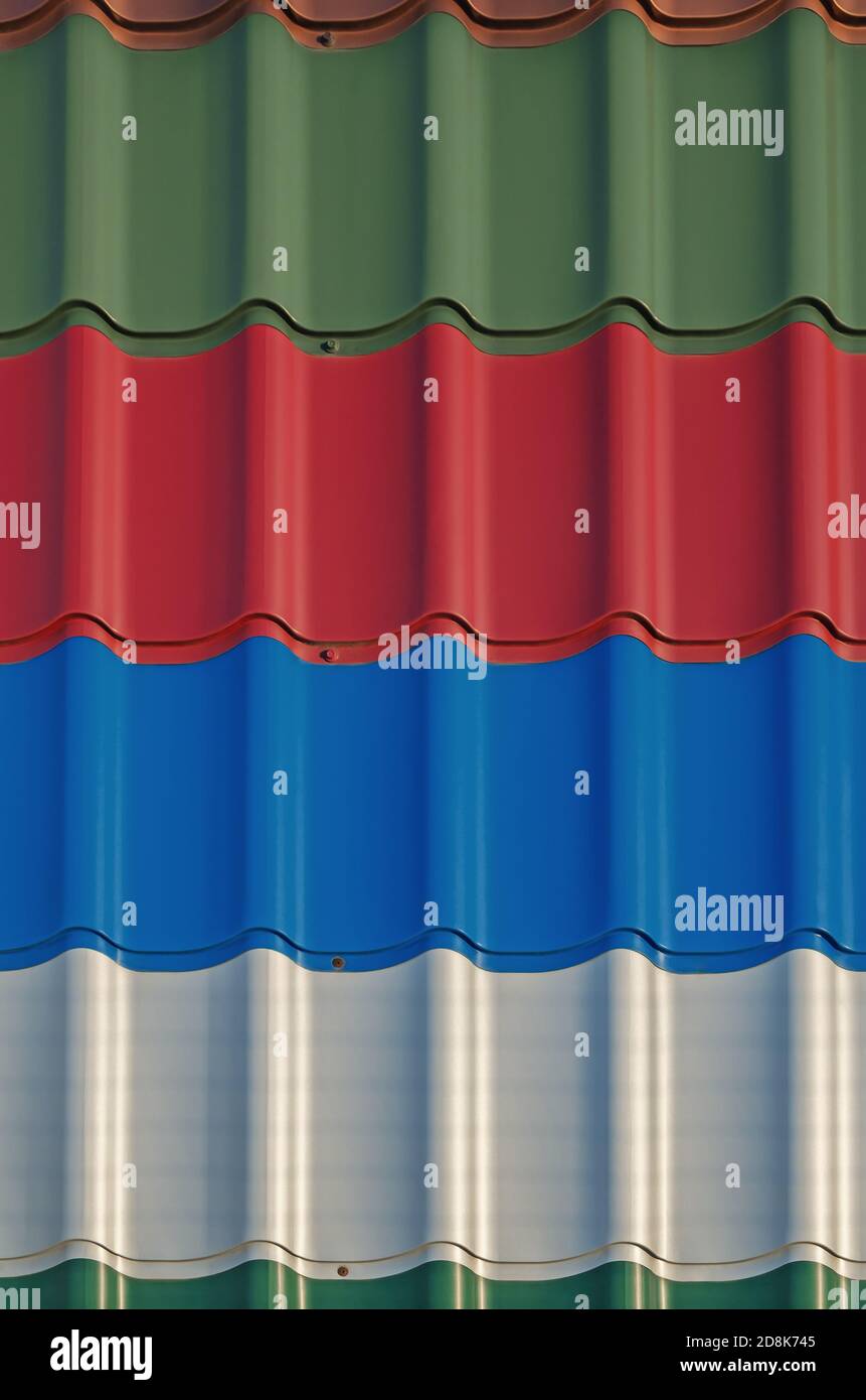 Metal shingles. Materials for the roof. Tiles of different colors. Roof ...