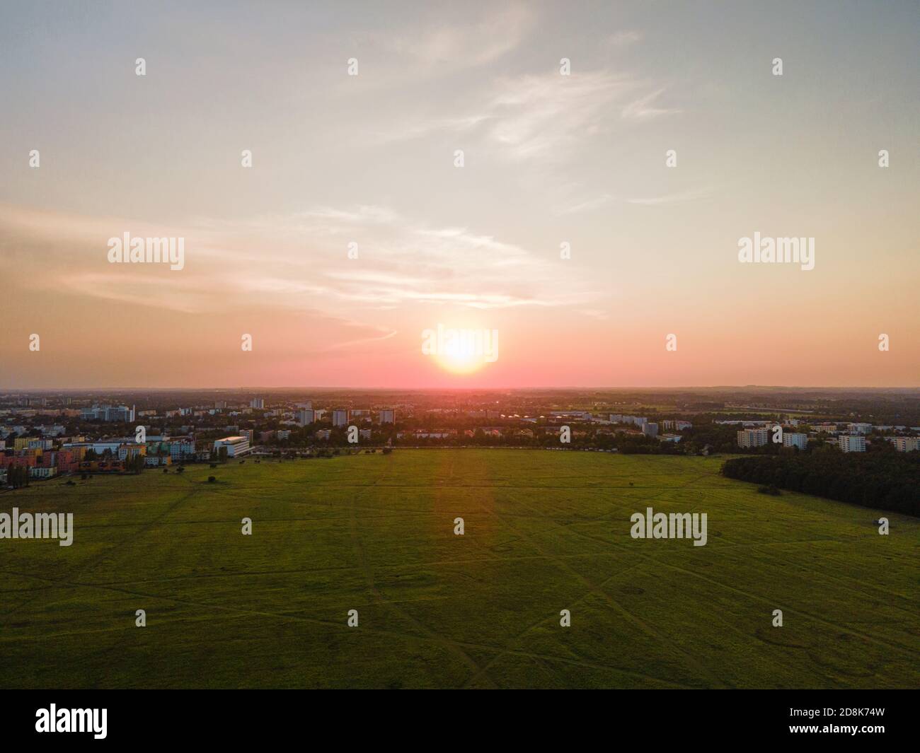 Aerial view of the lands by the small town during sunset Stock Photo ...