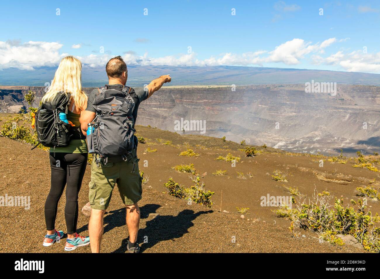 The Hiking couple seeing volcano national park from crater on the ...