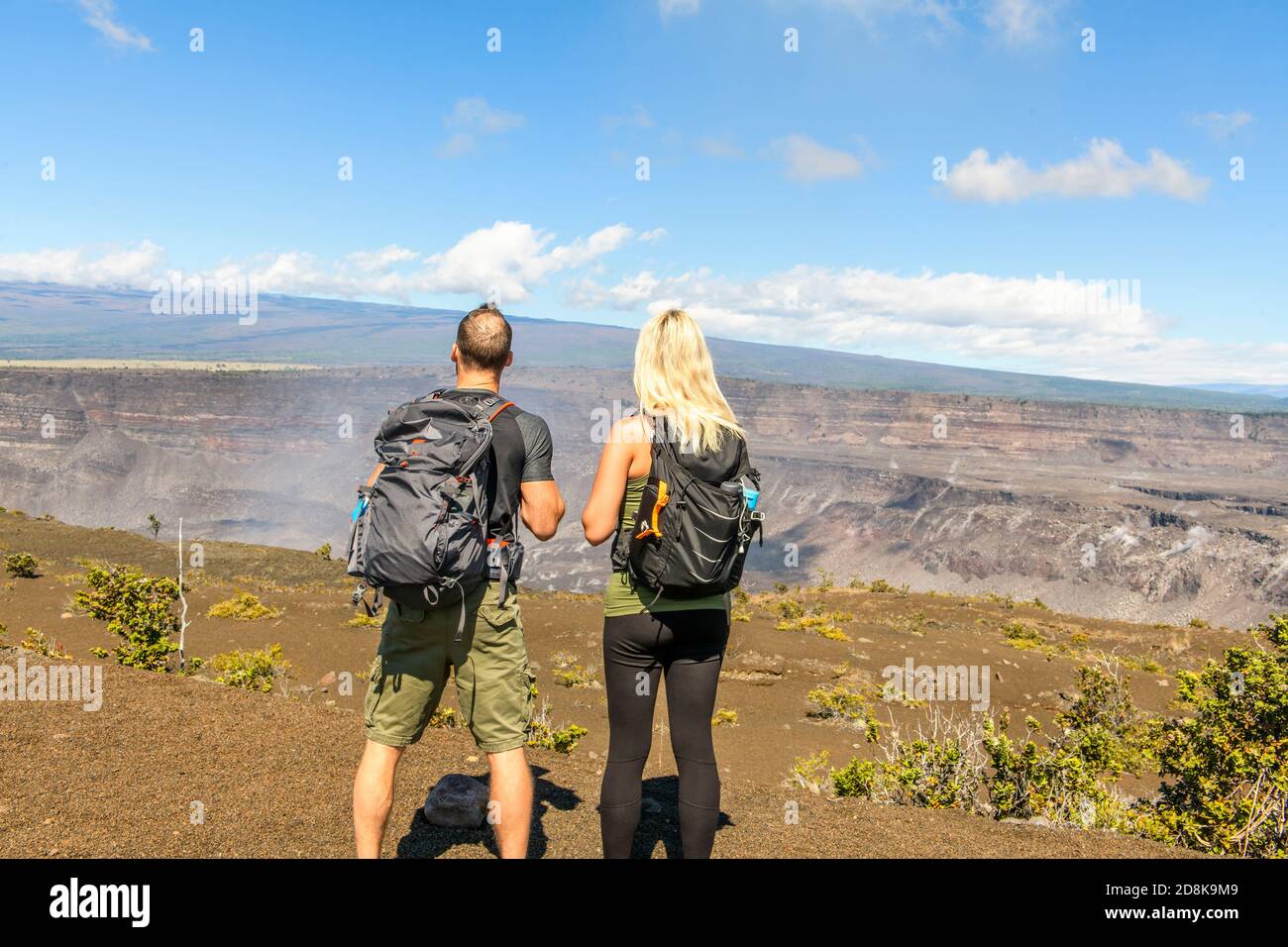 The Hiking couple seeing volcano national park from crater on the ...